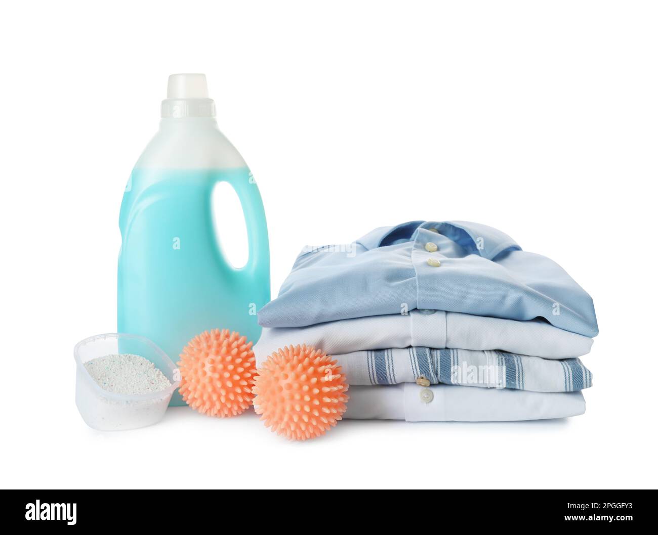 Orange dryer balls, detergents and stacked clean clothes on white ...