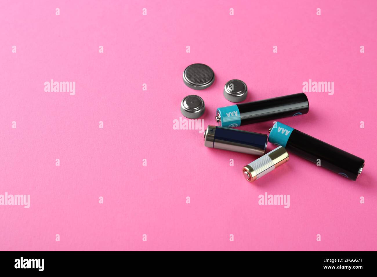 Different types of batteries on pink background, space for text Stock ...