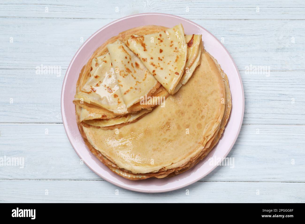 Delicious crepes on white wooden table, top view Stock Photo - Alamy