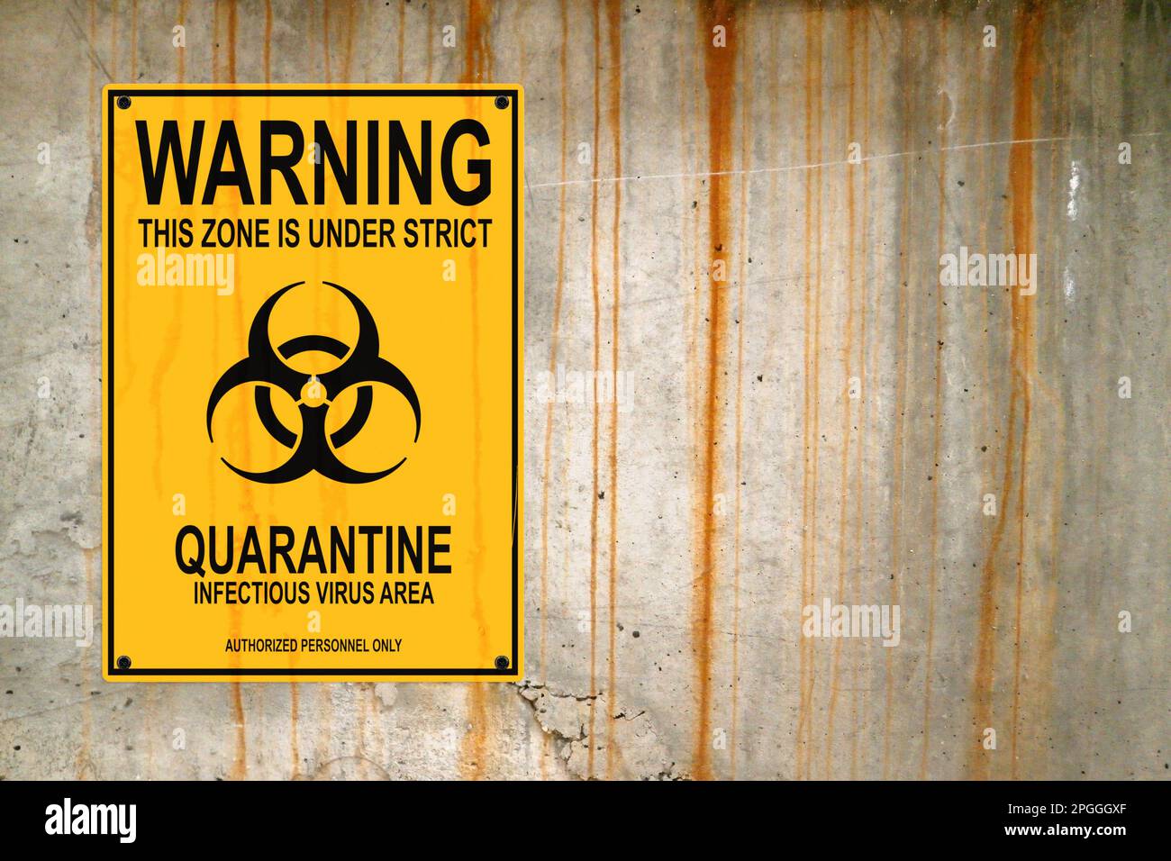 Yellow warning sign screwed to a concrete wall to warn about a threat ...