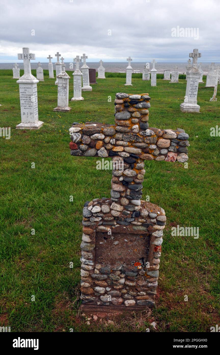 A grave marker made out of small stones stands in the seaside cemetery ...