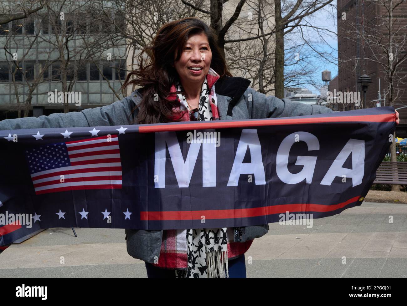 New York, New York, USA. 22nd Mar, 2023. Woman holds MAGA banner across ...