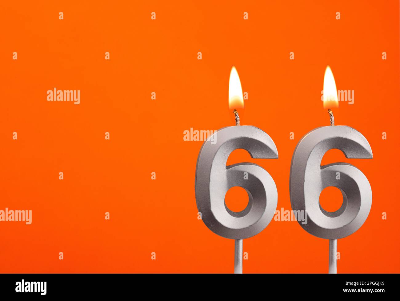 Candle number 66 - Birthday in orange background Stock Photo - Alamy