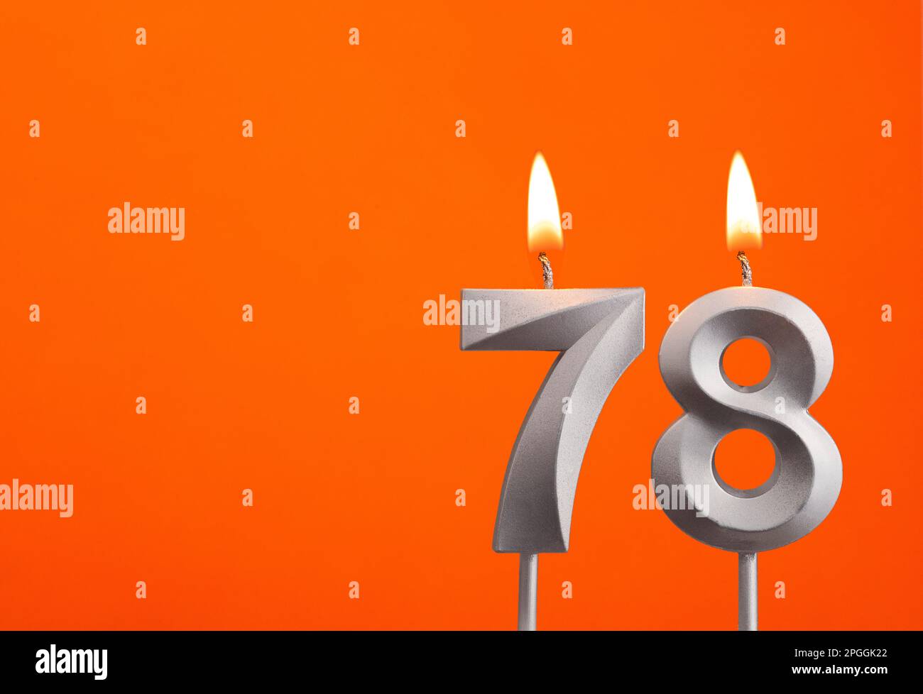Candle number 78 - Birthday in orange background Stock Photo - Alamy