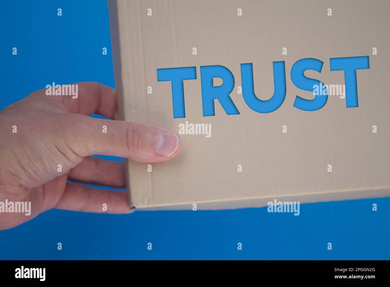Trust word with cardboard box. Brown folded card box Stock Photo - Alamy