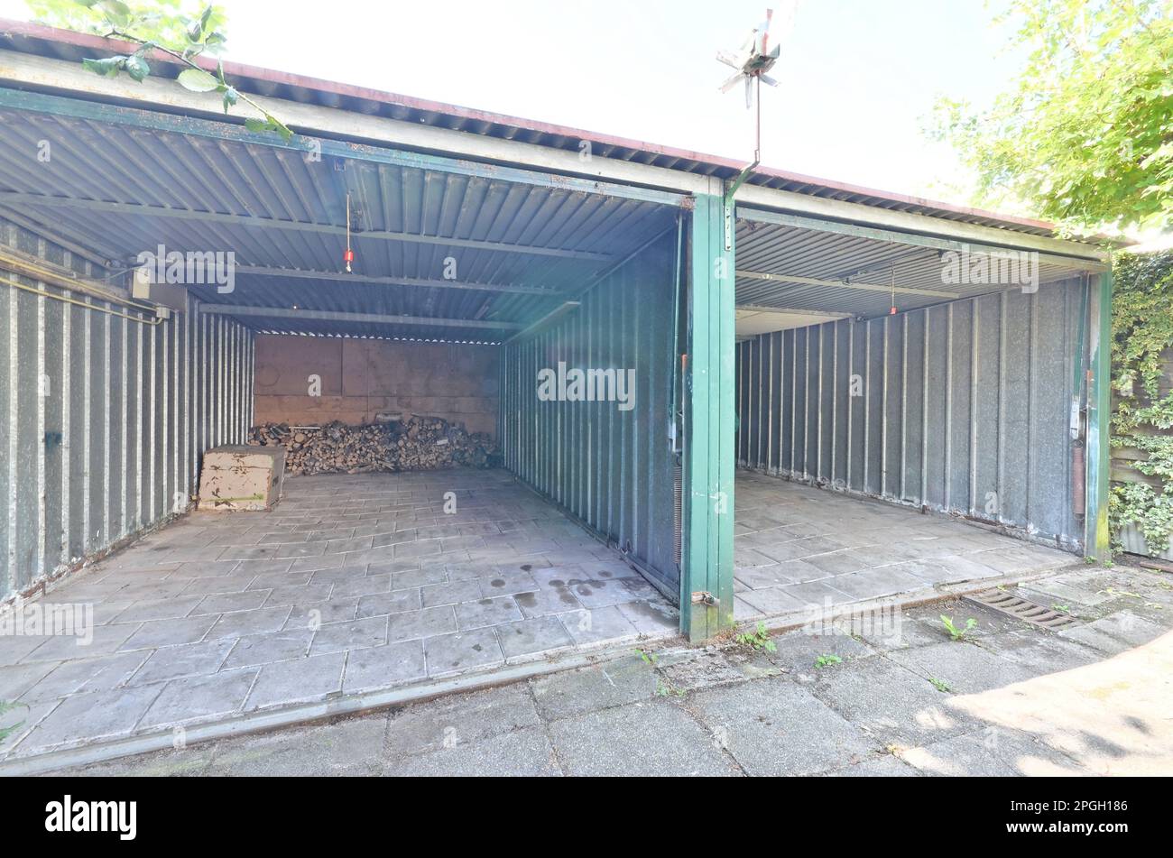 the inside of a building with lots of wood stacked on the floor and one ...