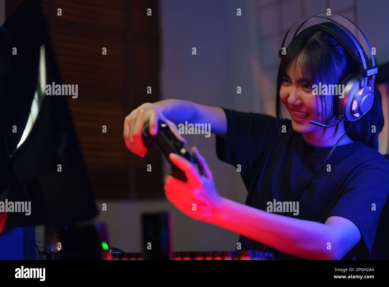 Female cyber hacker gamer in headphone playing video games on computer ...