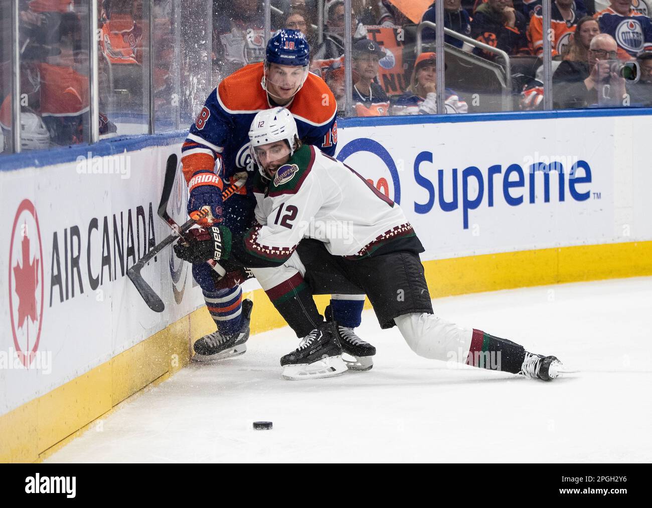 Arizona Coyotes' Connor Mackey (12) and Edmonton Oilers' Zach Hyman (18 ...