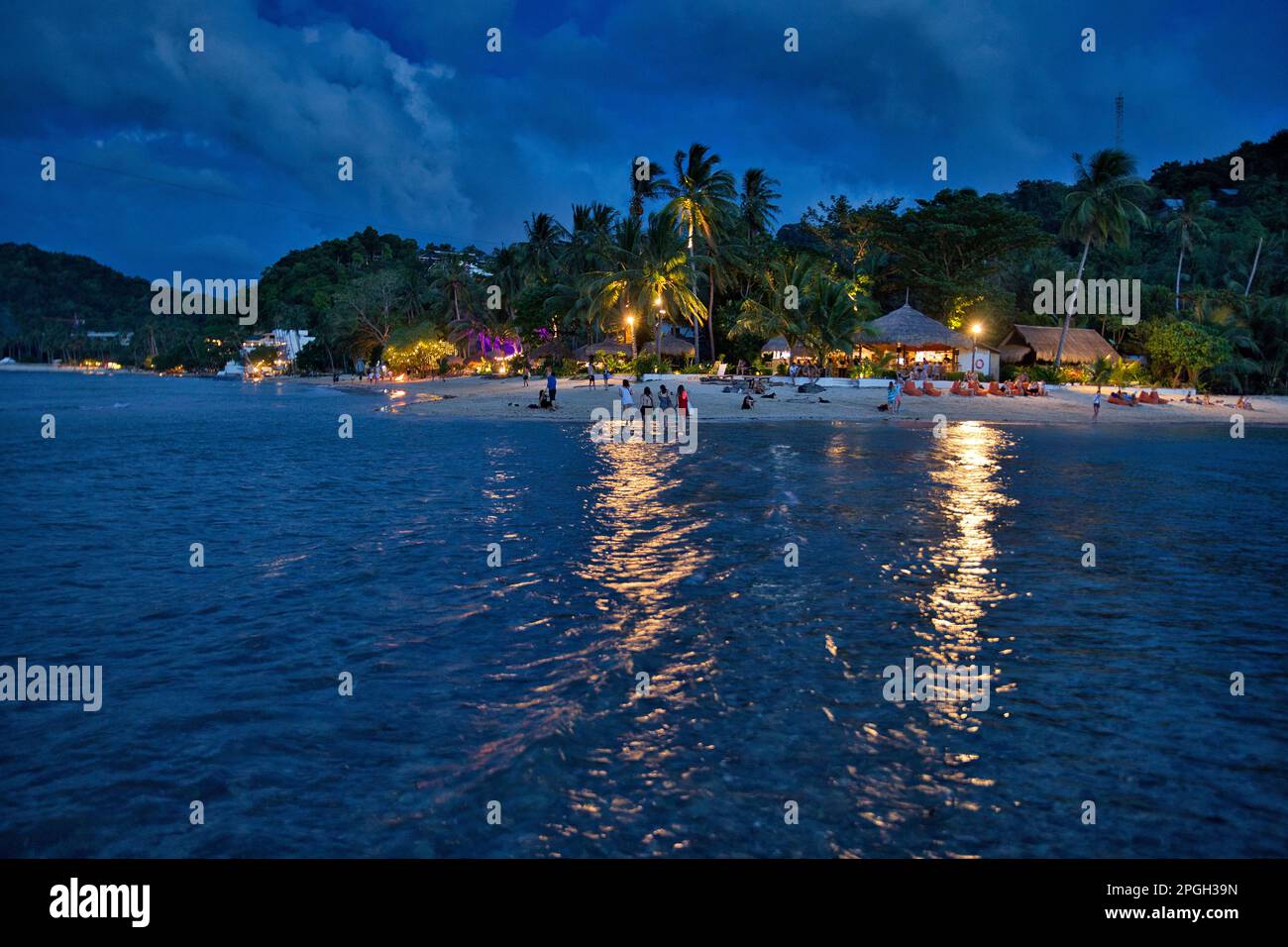 Sandy beach of El Nideo, Palawan in the Philippines at night, with ...