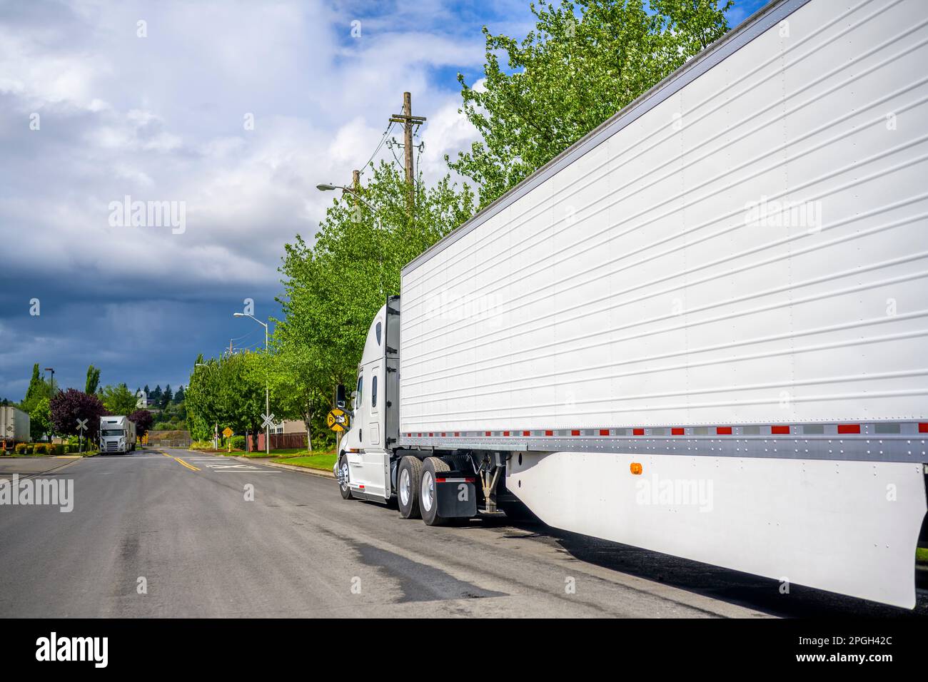 Industrial big rig white semi truck tractor with refrigerated semi ...