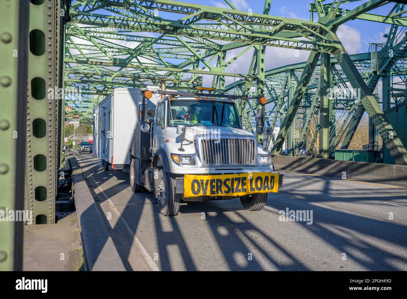 Classic American bonnet white big rig semi truck tractor with oversize ...