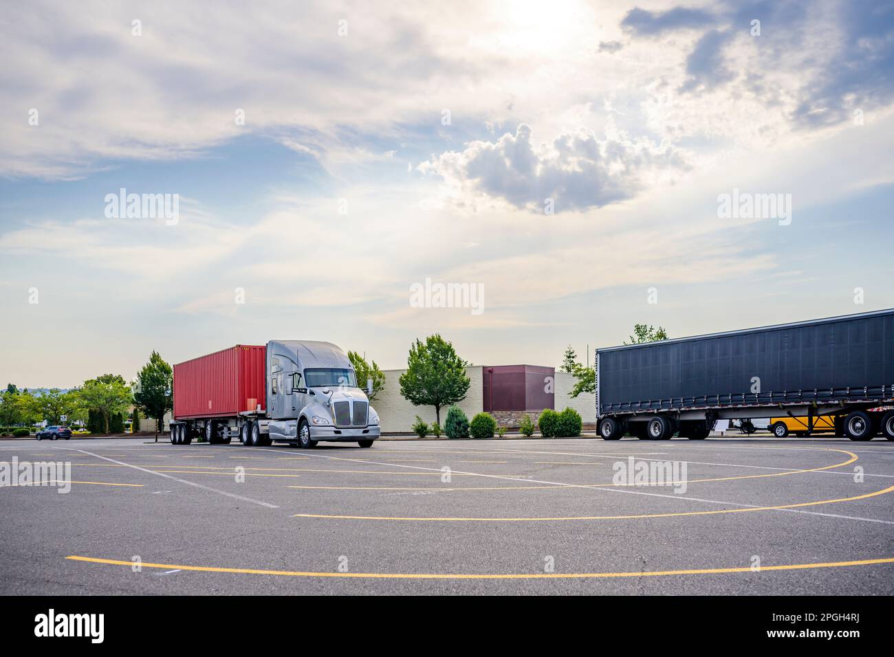 Industrial big rig gray high cab semi truck tractor with container on ...