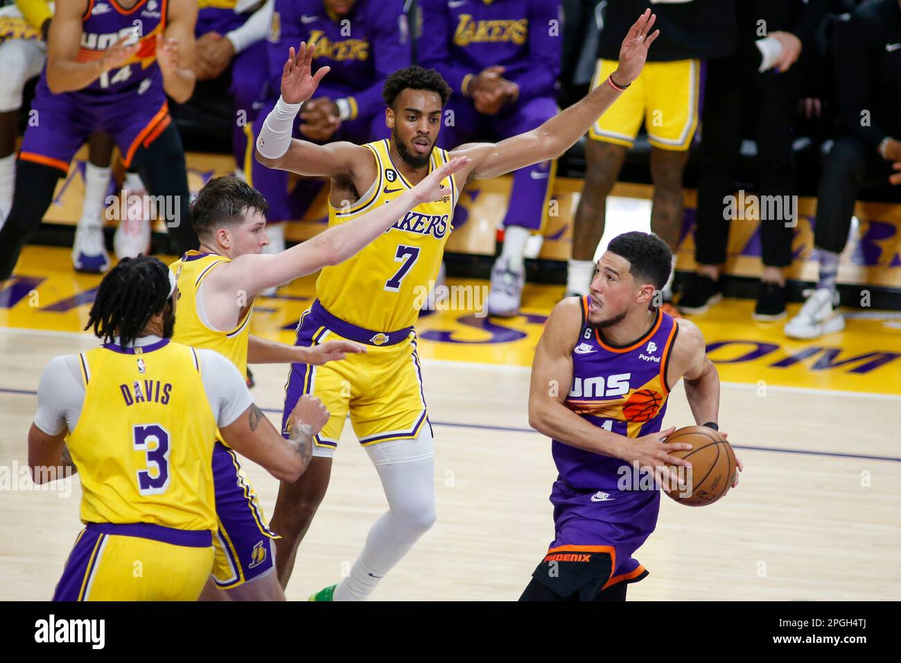 Los Angeles, California, USA. 22nd Mar, 2023. Phoenix Suns guard Devin Booker (R) drives against ...