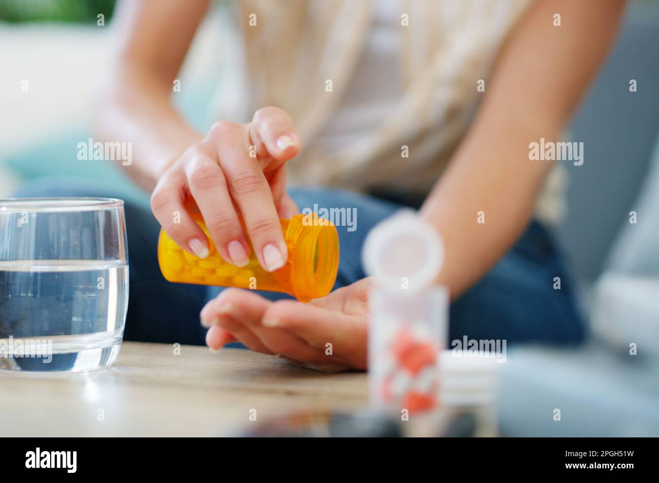 Do it for your health. a woman taking medication at home Stock Photo ...