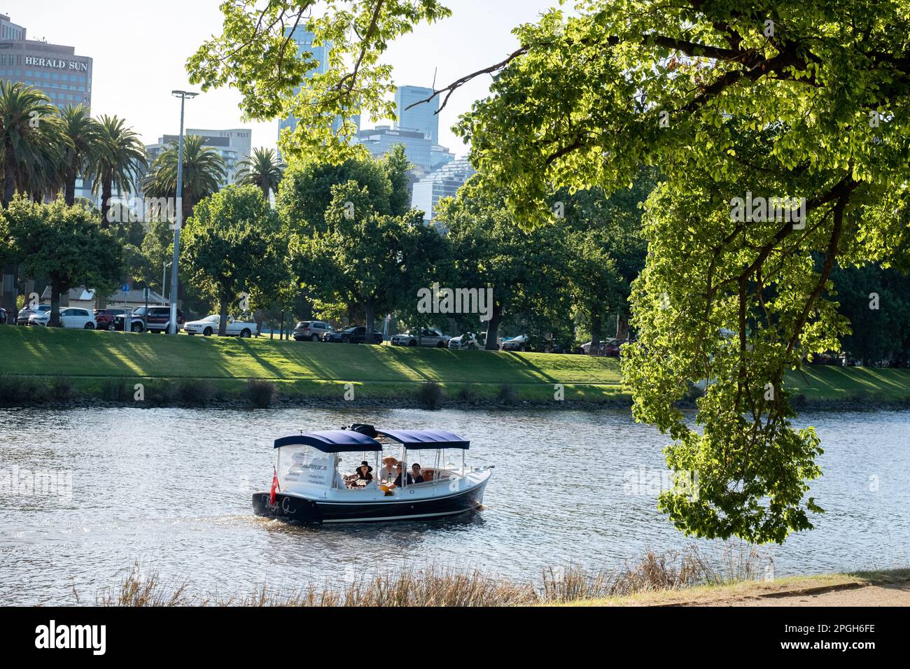 Tourists ride a boat along the Yarra River in Melbourne, Victoria ...