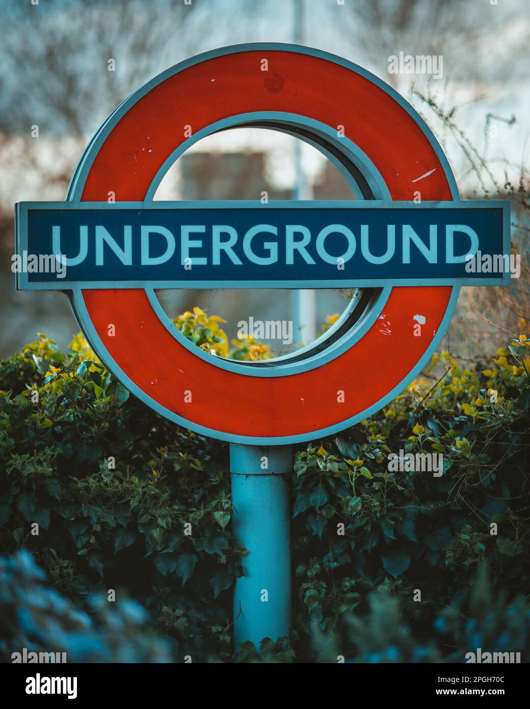 A bright underground sign is prominently displayed in the foreground of ...