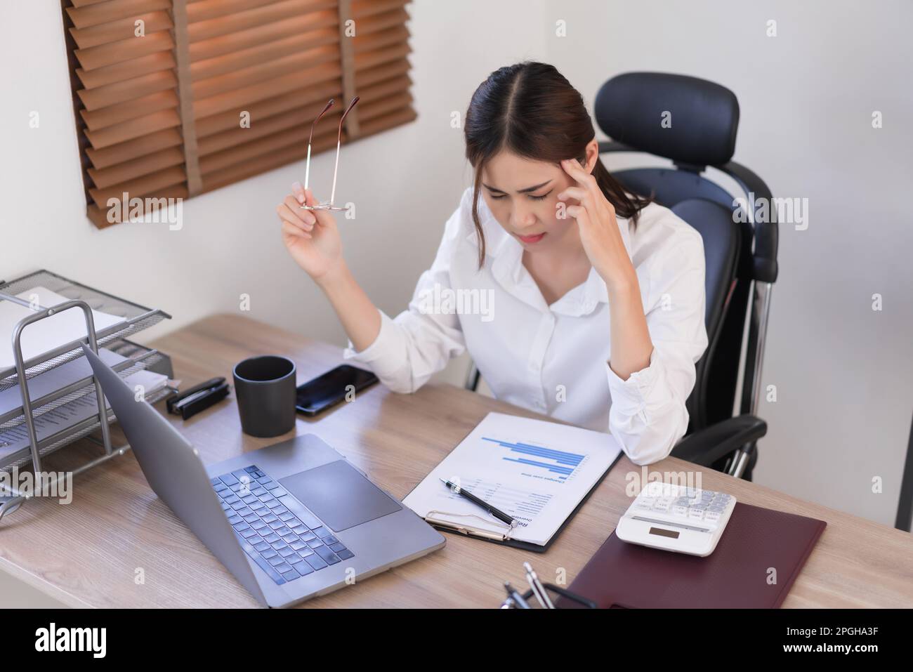 Business concept, Businesswoman holds glasses while feeling headache ...