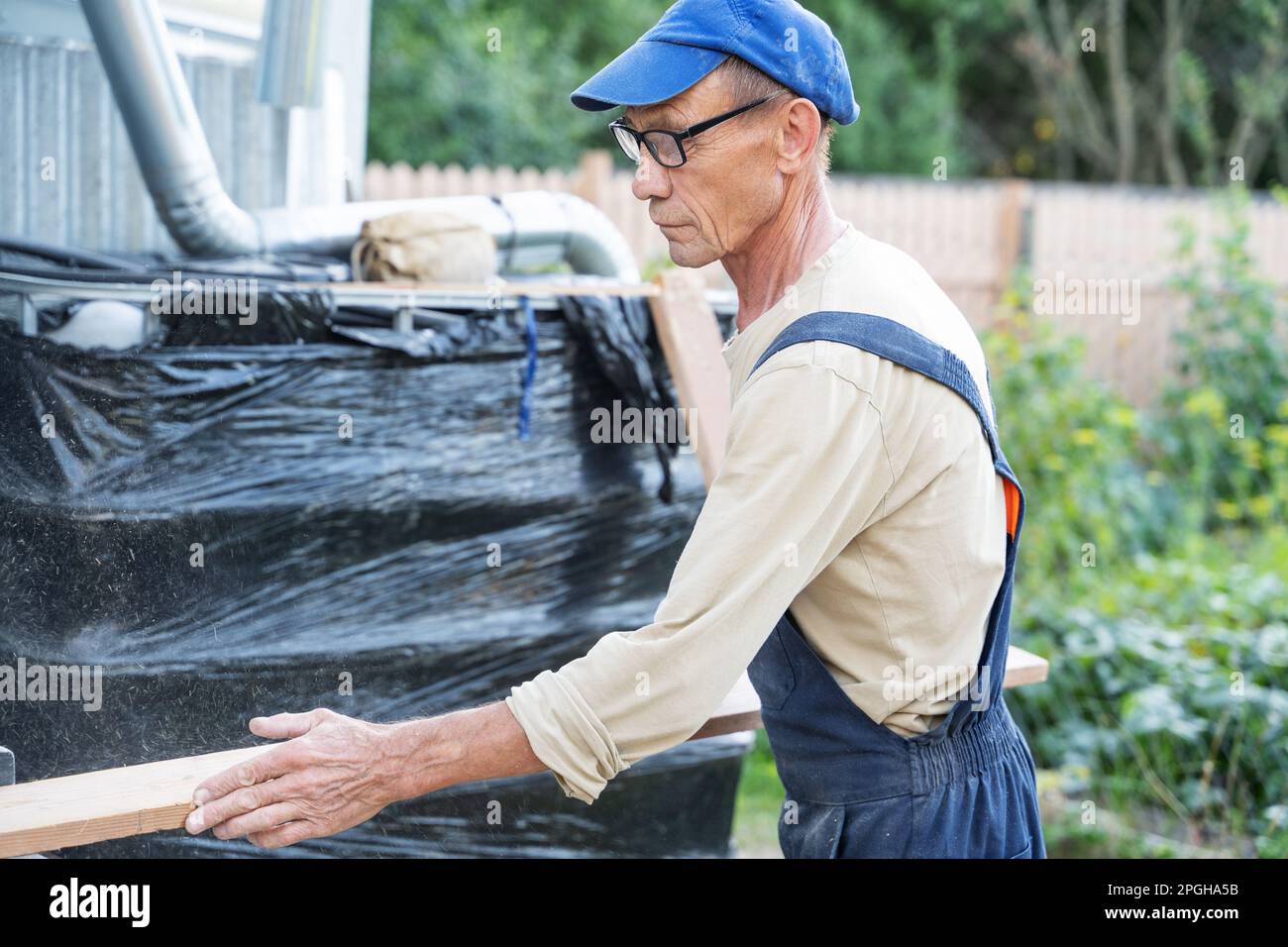 Work on the infield. Do it yourself. A carpenter processes wooden ...