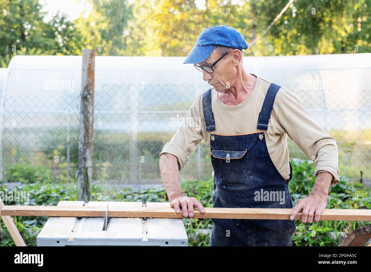 Work on the infield. Do it yourself. A carpenter processes wooden ...