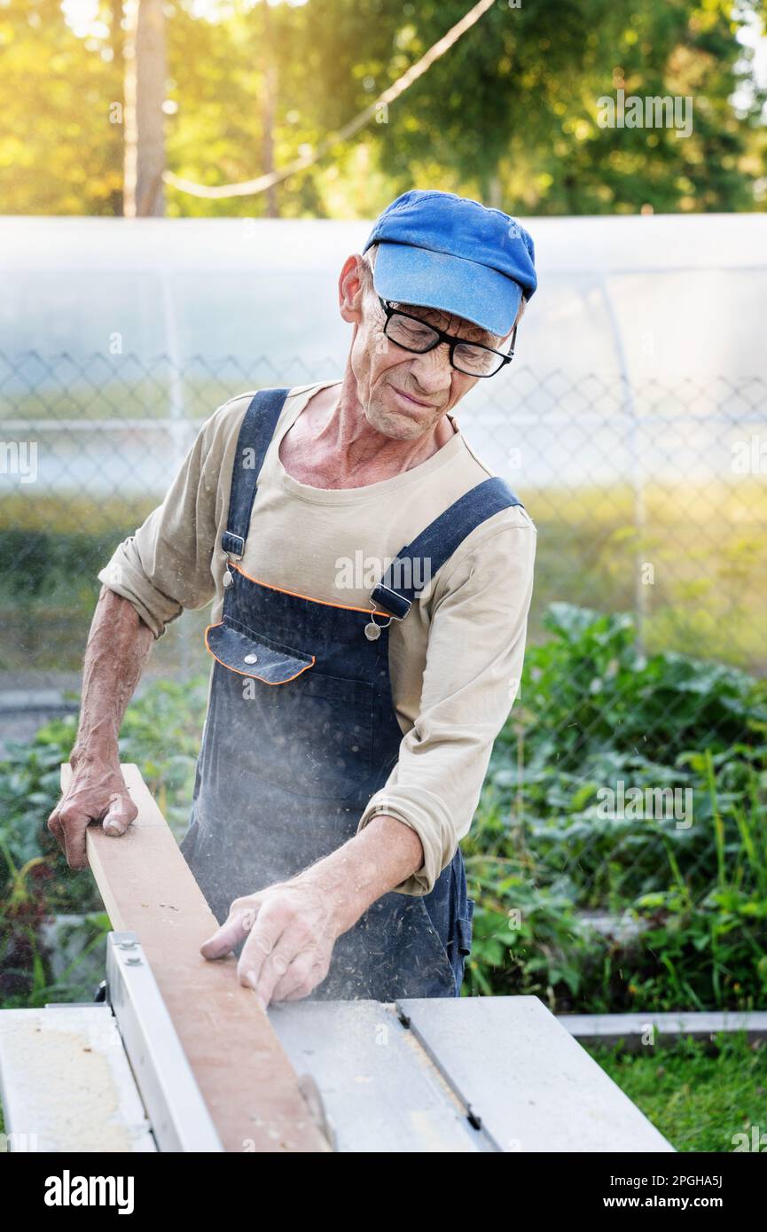 Work on the infield. Do it yourself. A carpenter processes wooden ...
