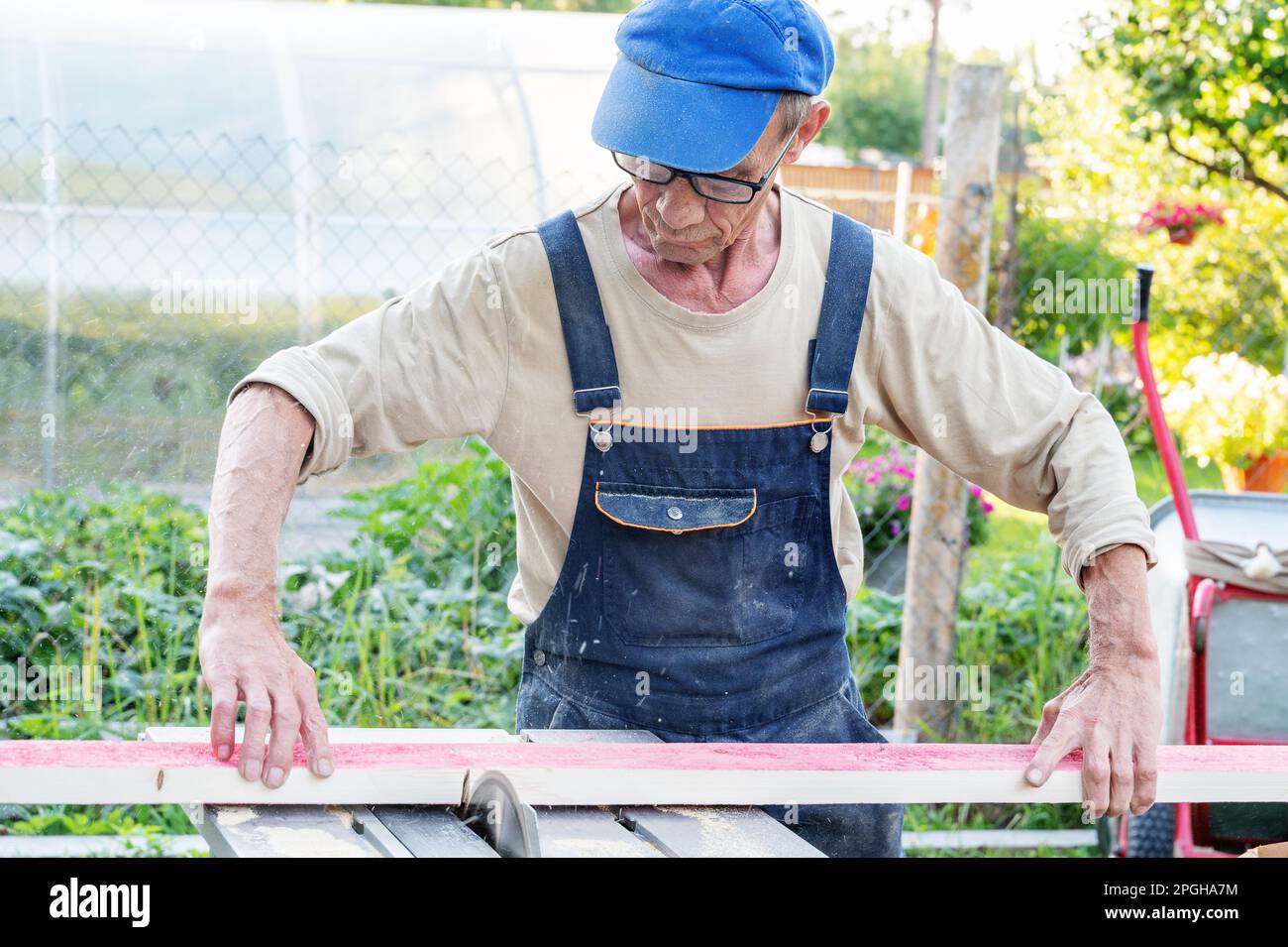 Work on the infield. Do it yourself. A carpenter processes wooden ...