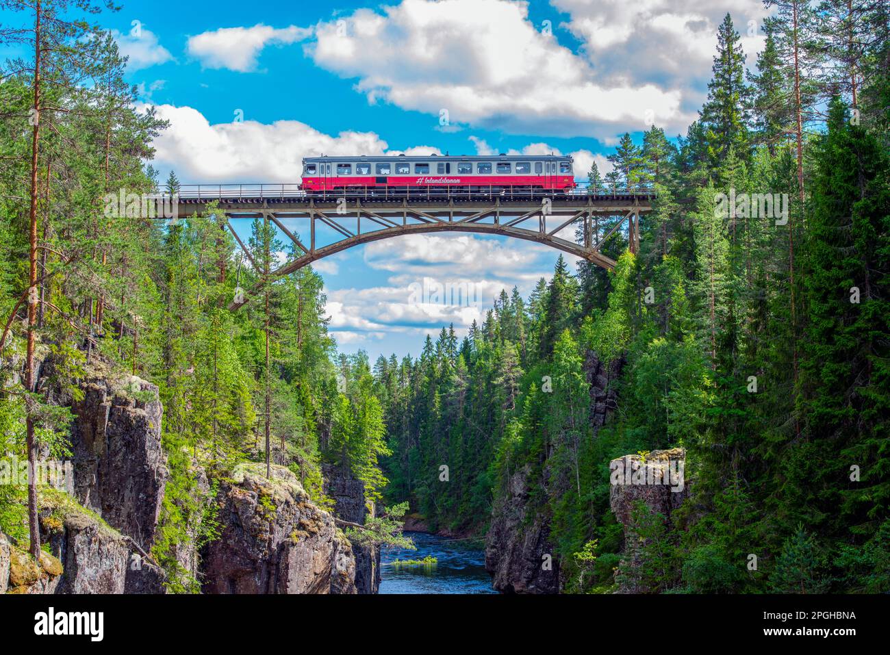 A train of the Swedish inlandsbanan, Inland railway, crossing a steel ...