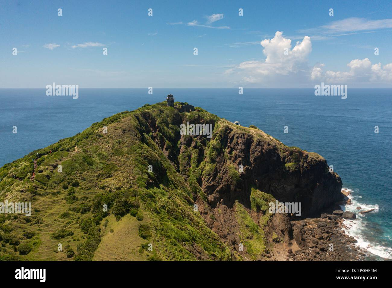 Aerial drone of old lighthouse on a cape against the backdrop of the ...