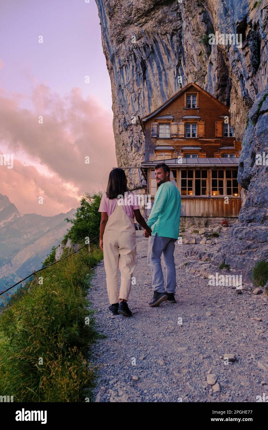 Couple of men and women hiking to Berggasthaus Aescher in den ...