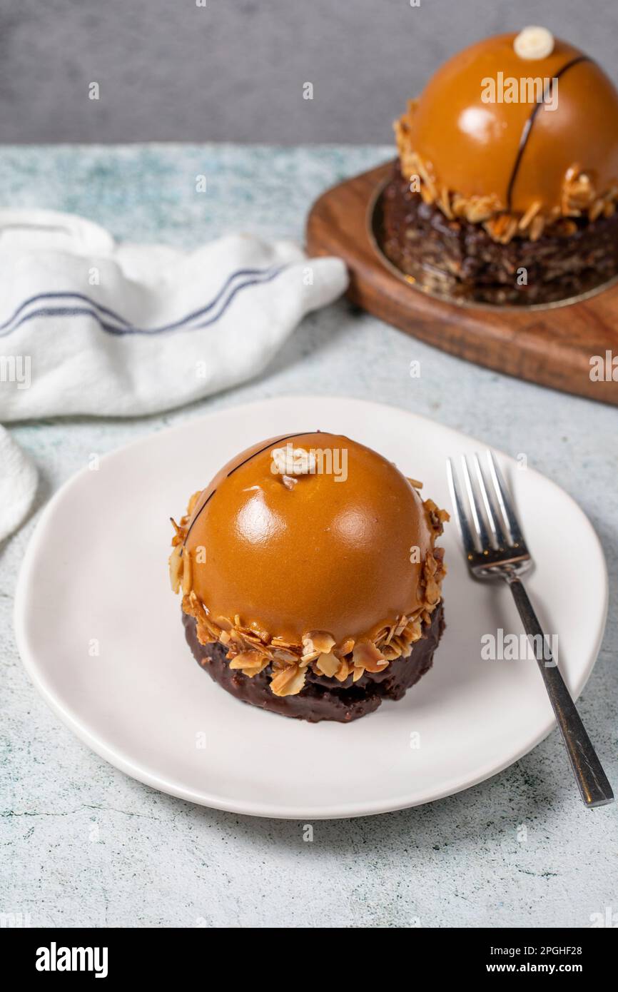 Round caramel cake. Hazelnut and cream portion cake Stock Photo - Alamy