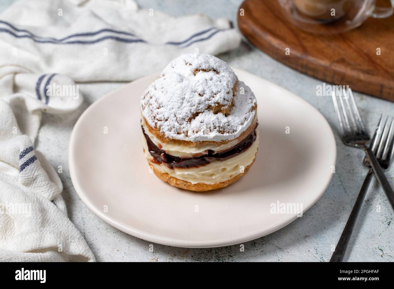 Cake with cream and liquid chocolate filling. Powdered Sugar Cake Stock ...