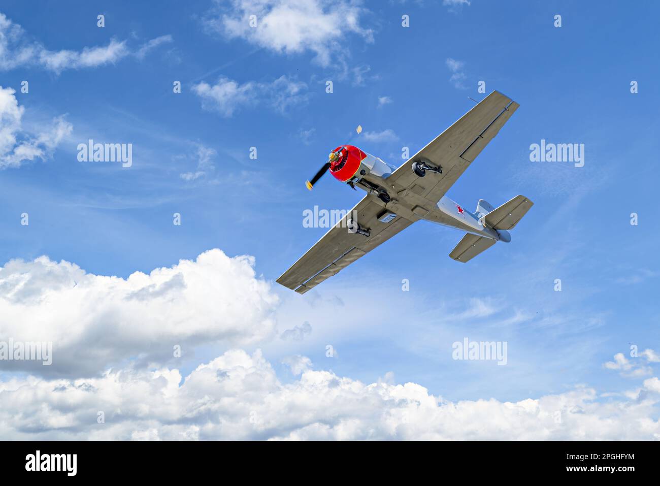 View of an aerobatic plane (aerodyne), in flight under a blue sky with ...