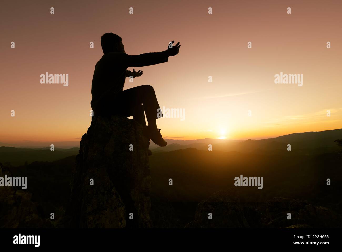 Man praying at sunset mountains raised hands Travel Lifestyle spiritual ...