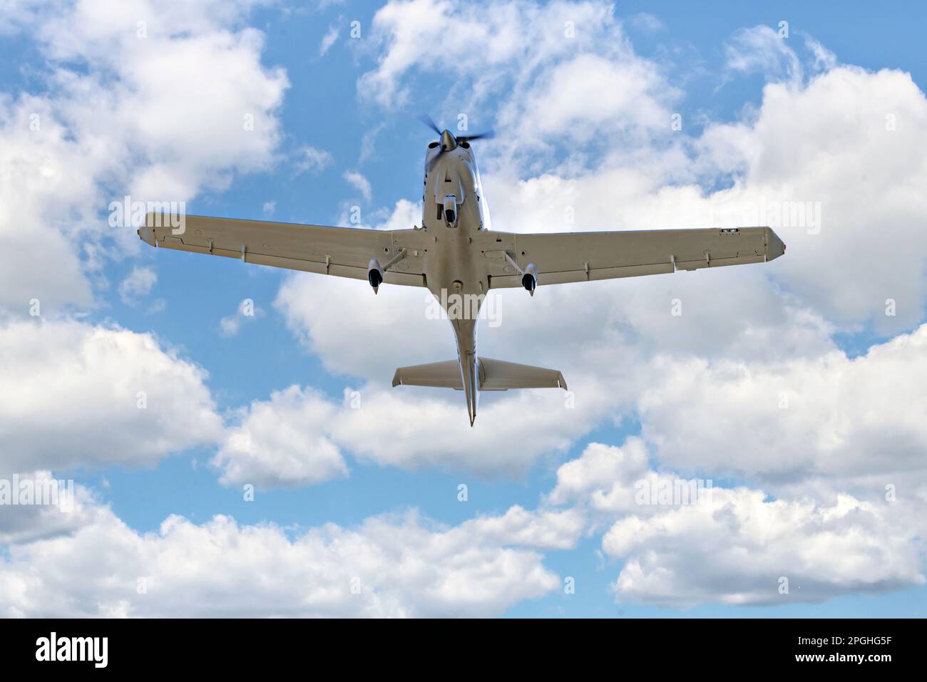Single engine ultralight plane flying in the blue sky with white clouds ...