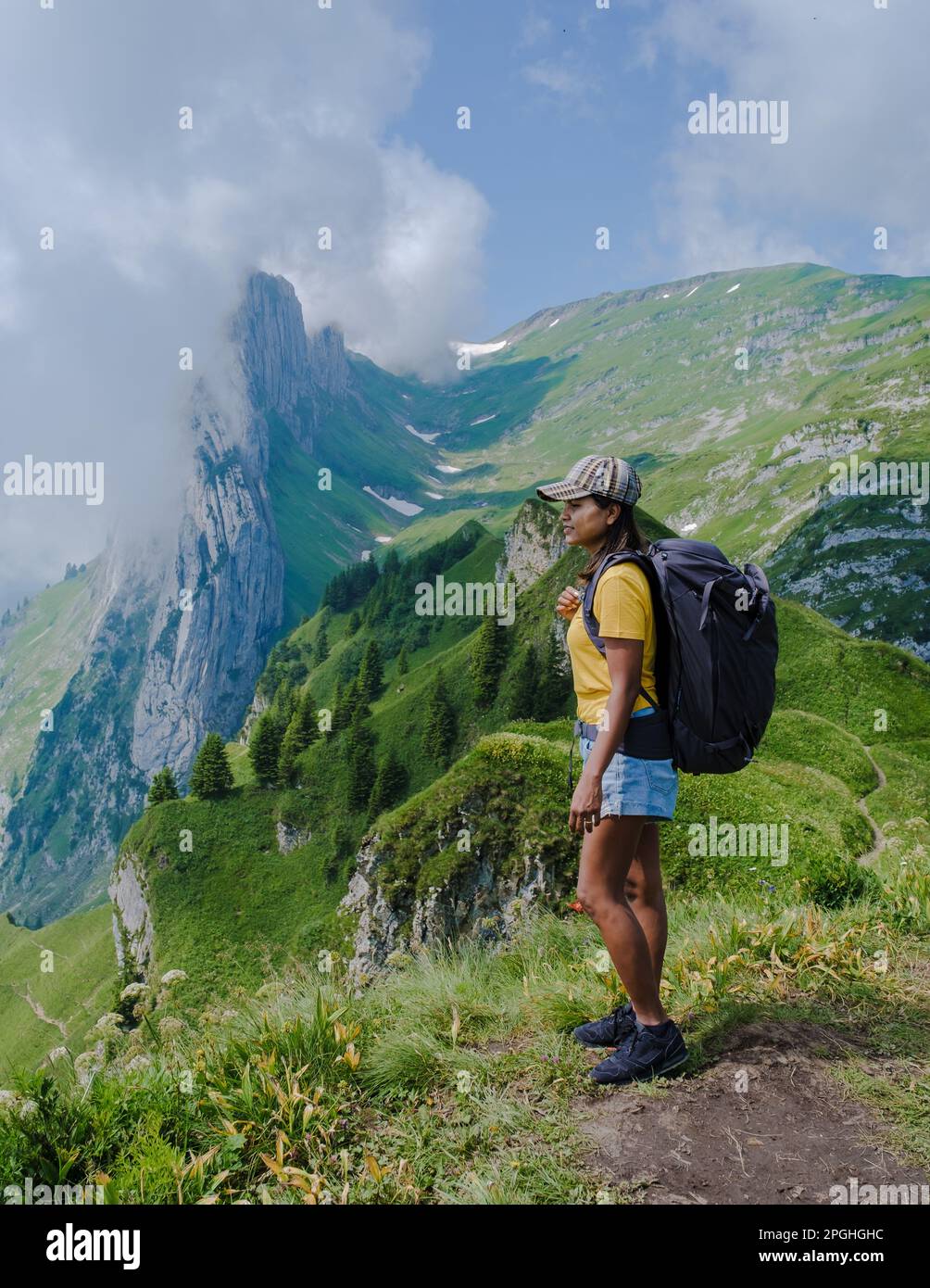 women hiking in the Swiss Alps mountains during summer vacation with a ...