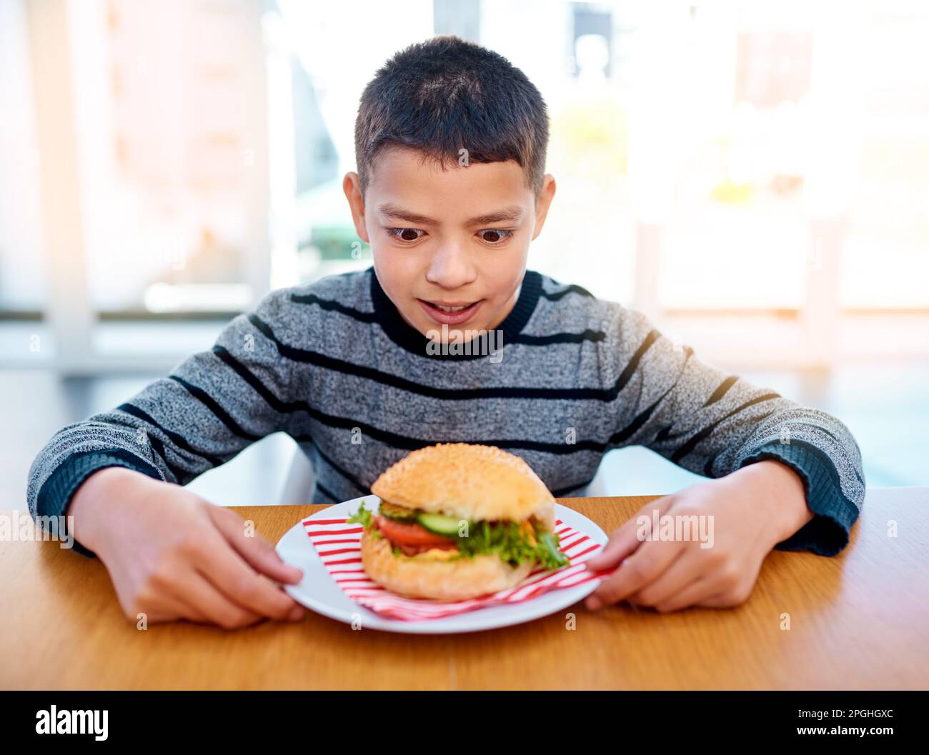 Growing boys have the biggest appetite. a young boy looking at his ...