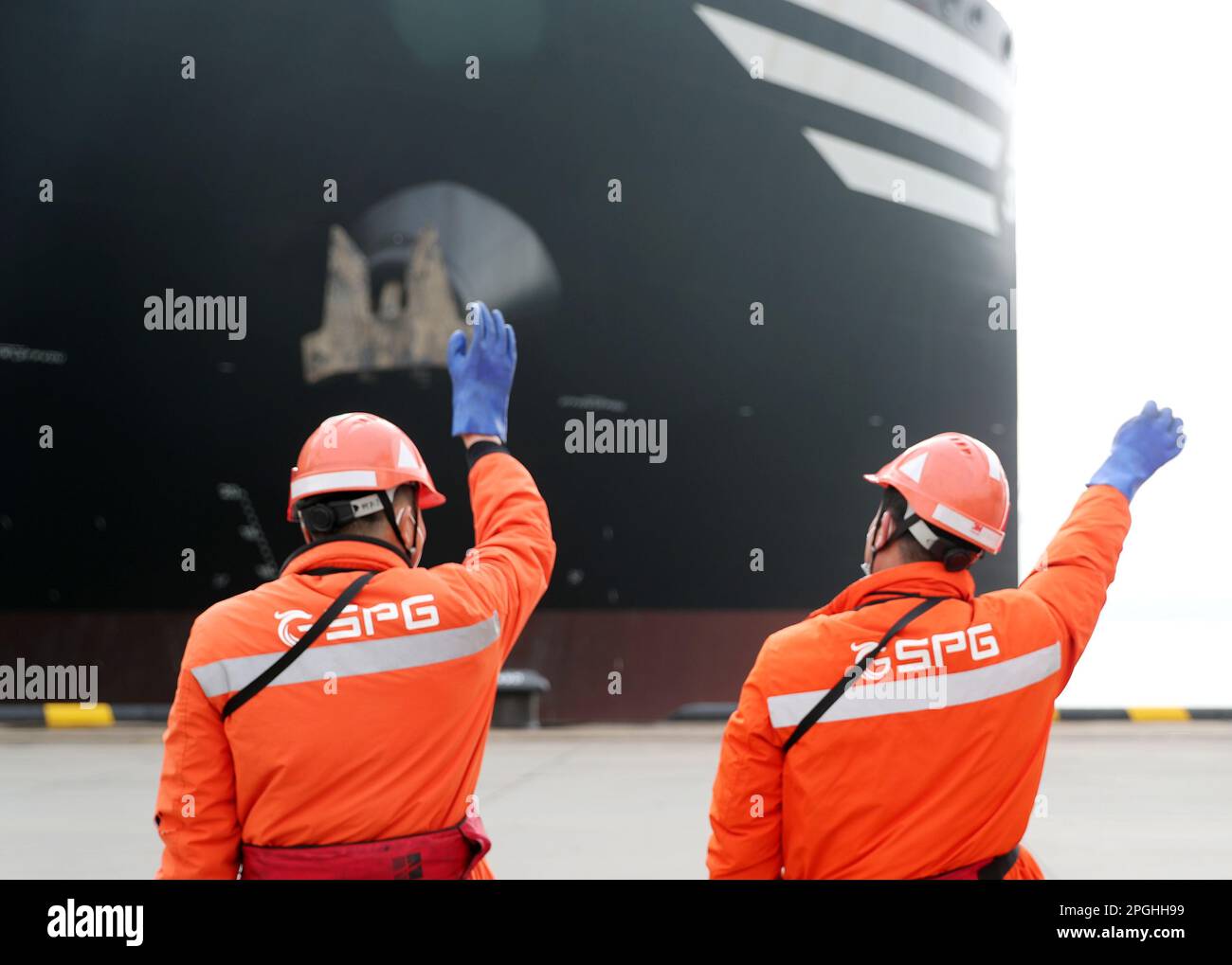QINGDAO, CHINA - MARCH 23, 2023 - Dockworkers wave goodbye to the ...