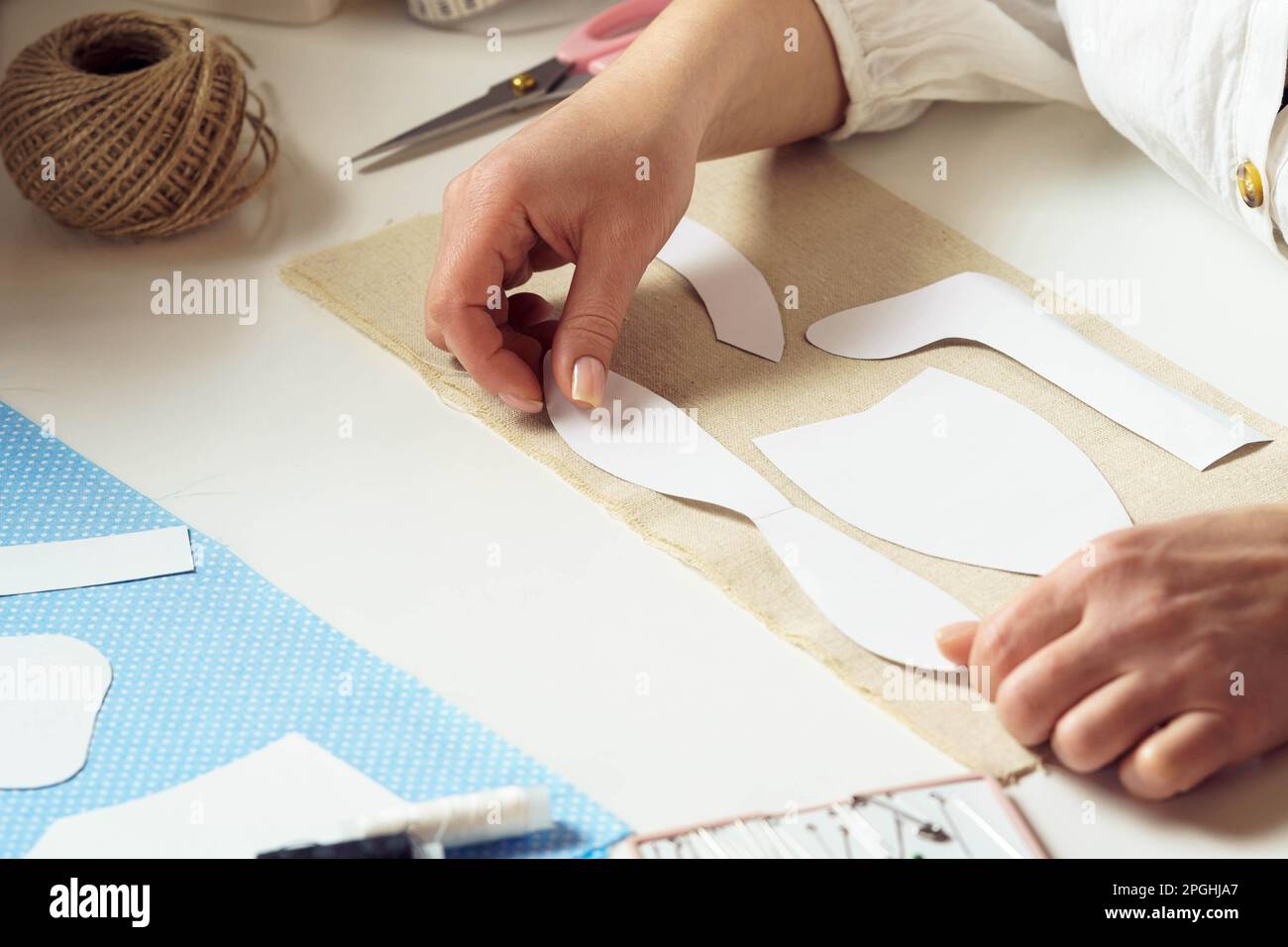 Unrecognizable close up women, seamstresses holding and placing paper ...
