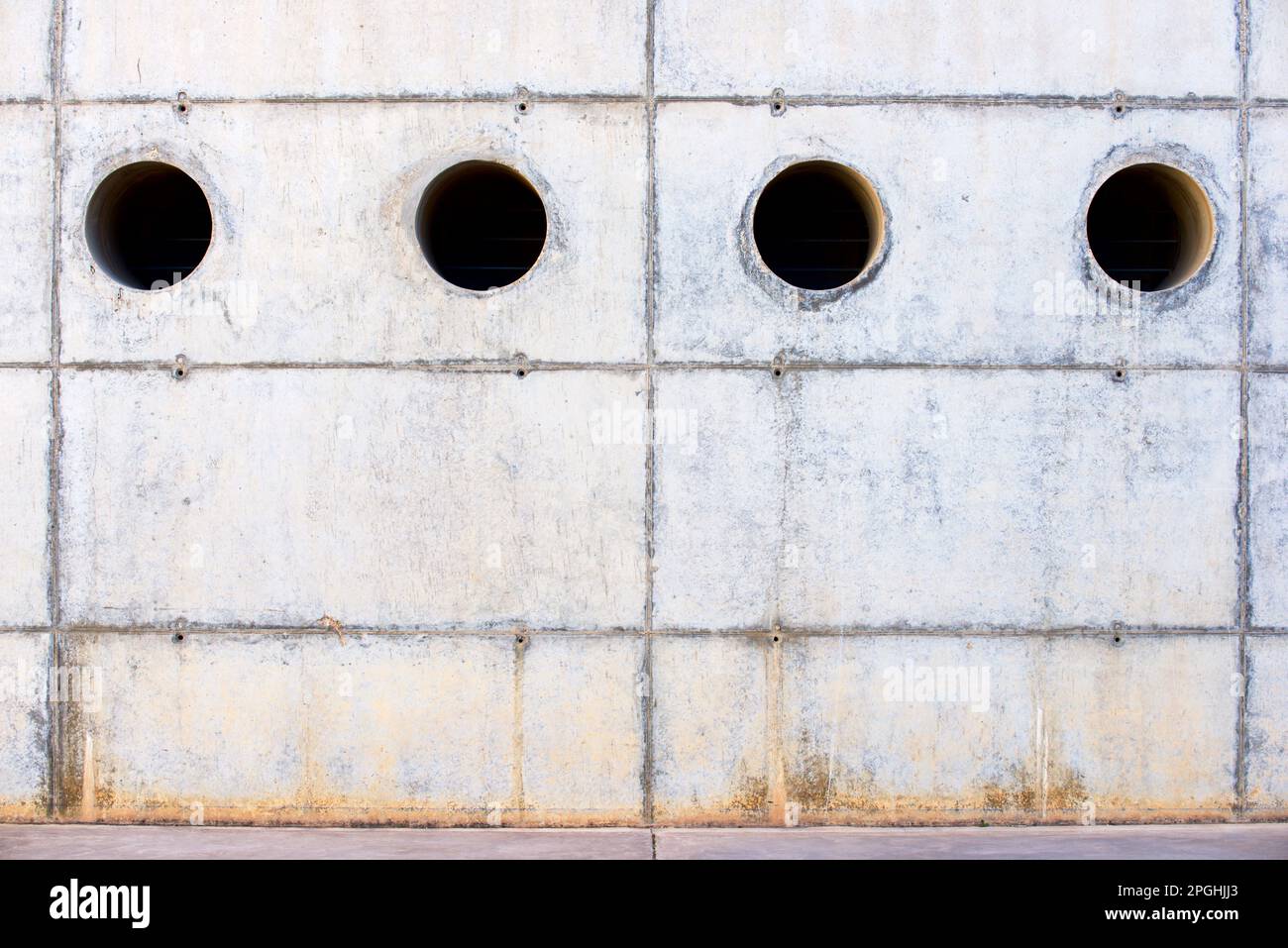 Pipelines for water drainage in a concrete wall, located in a park with ...