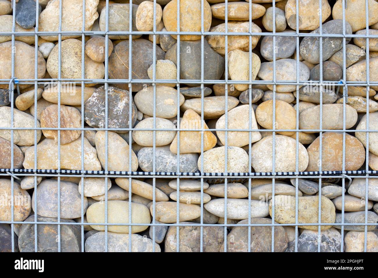 Wall formed by pebbles and metal mesh for ground support Stock Photo ...