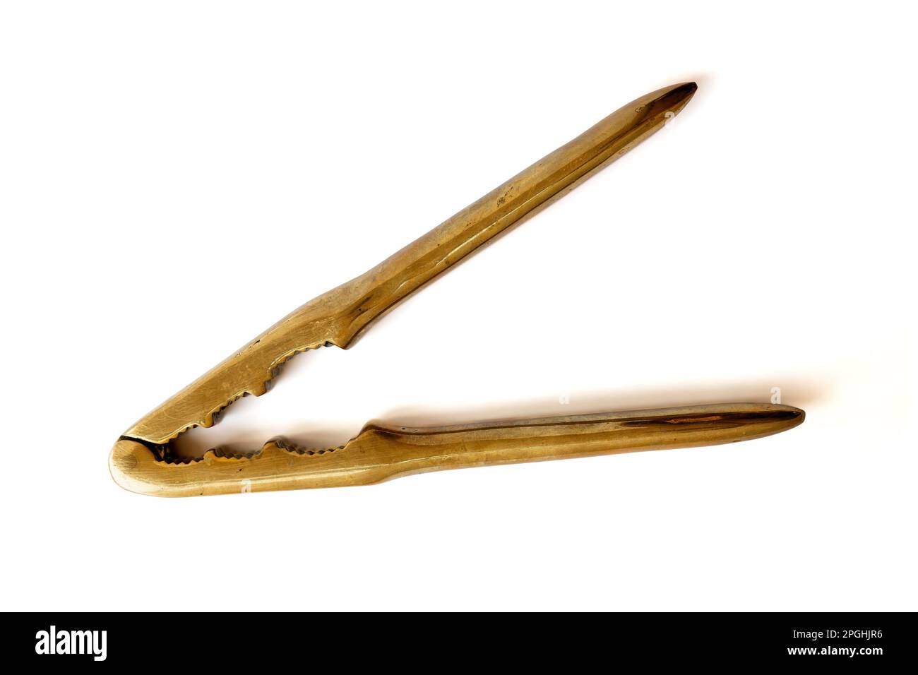 Open antique brass nutcracker on white background Stock Photo - Alamy