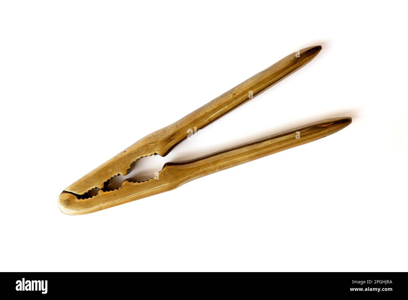 Closed antique brass nutcracker on white background Stock Photo - Alamy