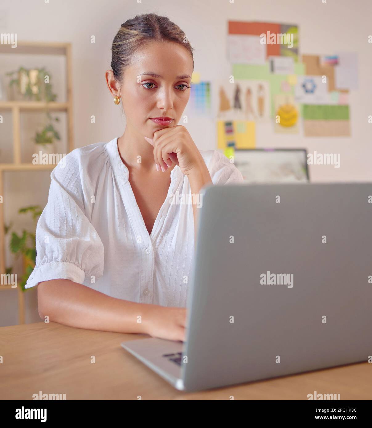 Laptop focus, thinking and business woman, fashion designer or stylist ...