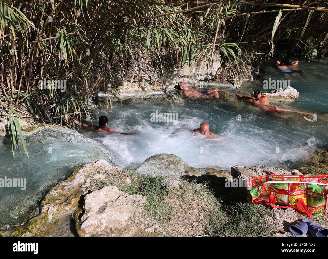 Saturnia, Italy - September 13, 2022: People are bathing in the hot ...