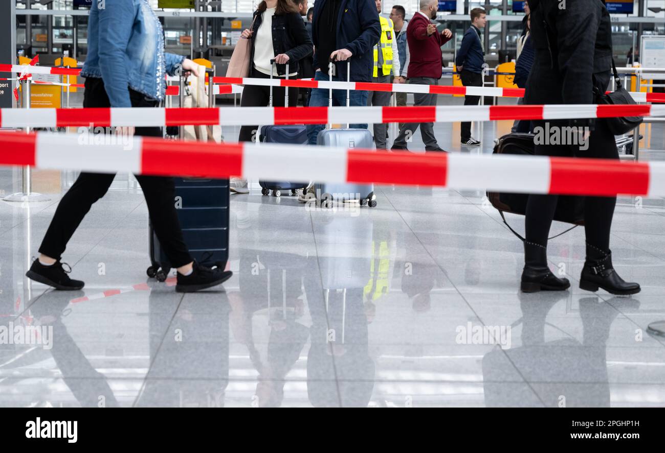 Munich, Germany. 23rd Mar, 2023. Passengers go to the security check at ...