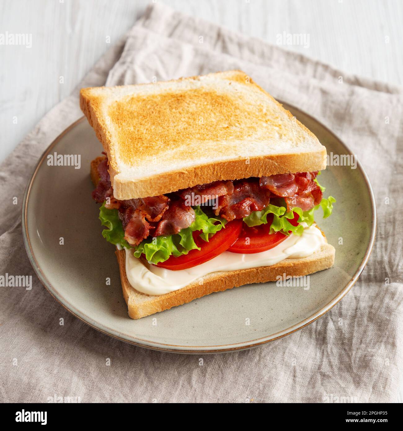 Homemade BLT Sandwich (Bacon, Lettuce and Tomato) on a Plate, side view ...
