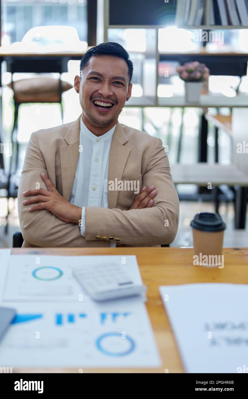 Portrait of a male business owner showing a happy smiling face as he ...