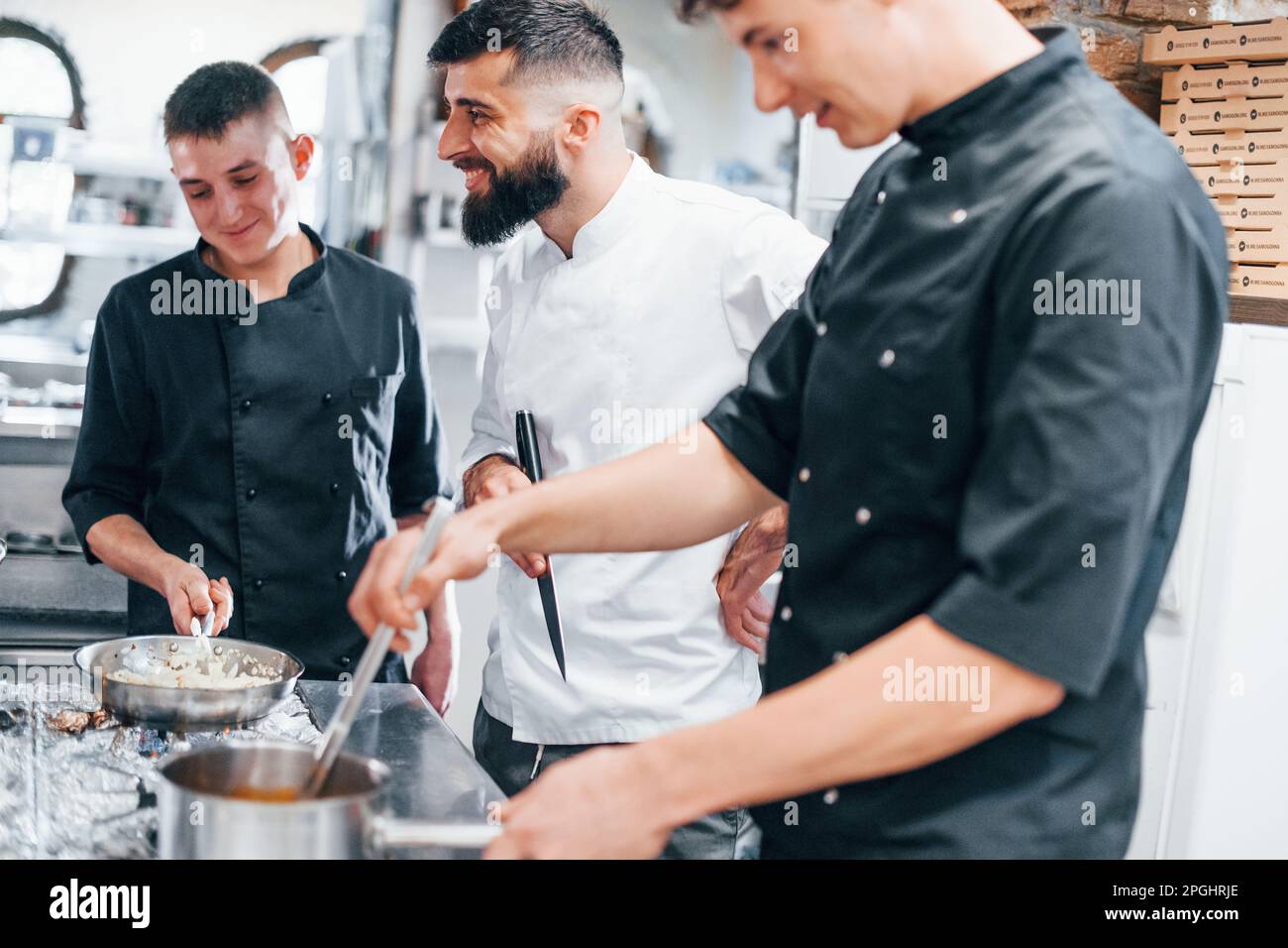 Group of people cooking food at kitchen together. Busy day at work ...
