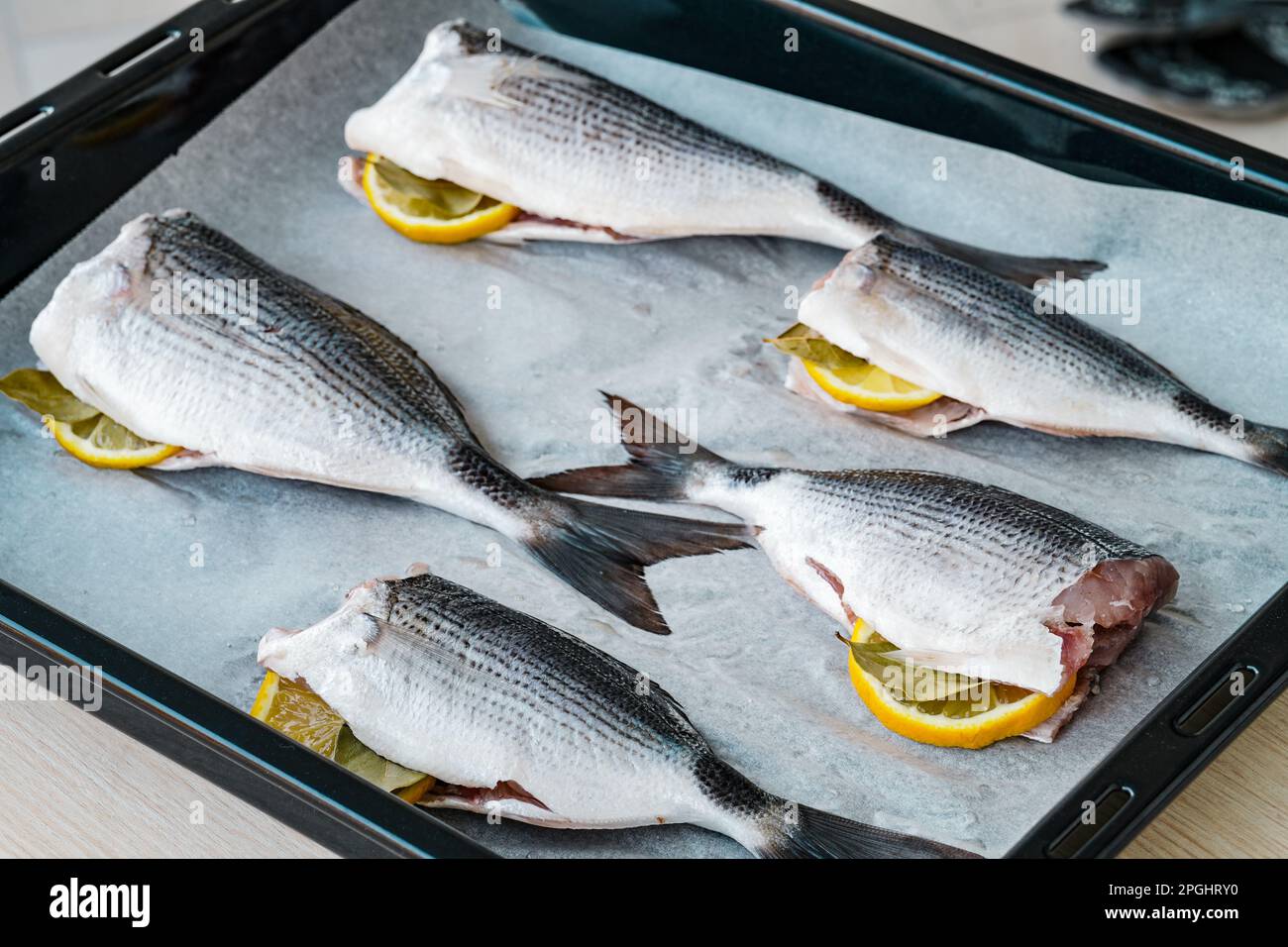 Fish ready on the baking tray sheet and baking paper, lemon daphne, sea ...