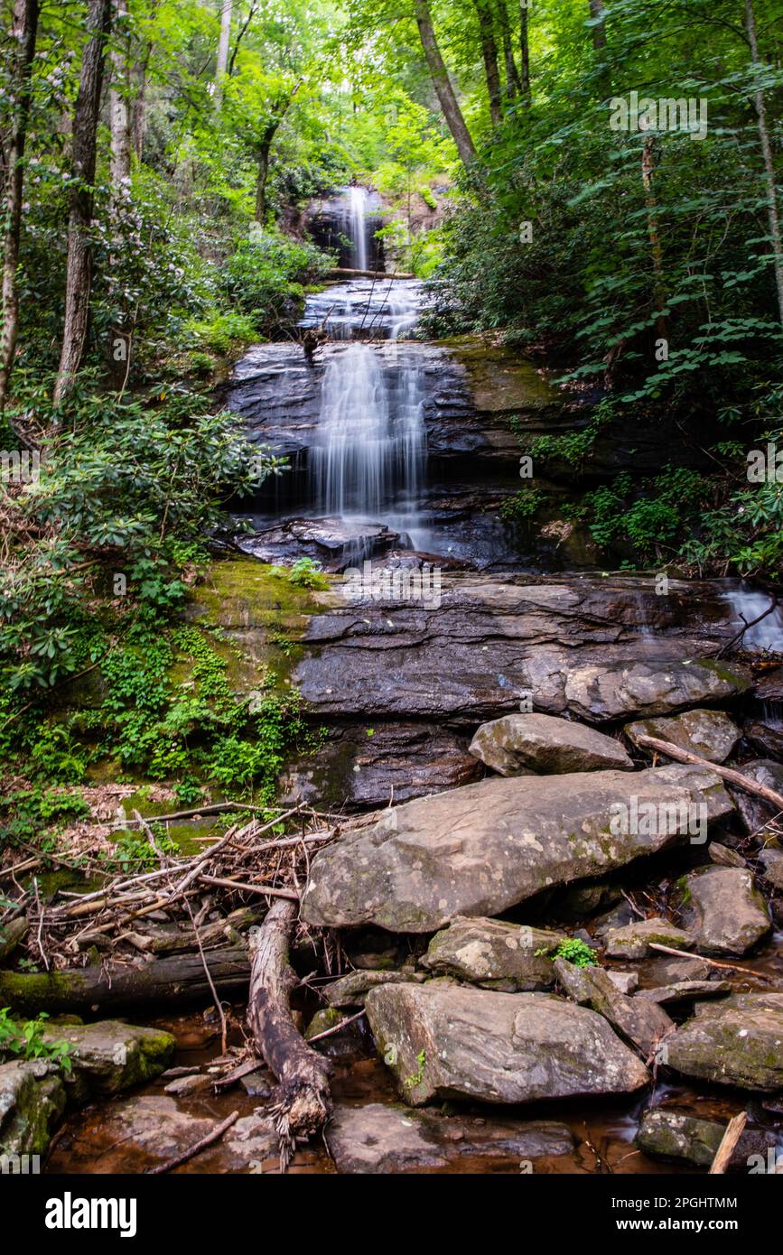 Serene waterfall cascades through lush greenery hi-res stock ...