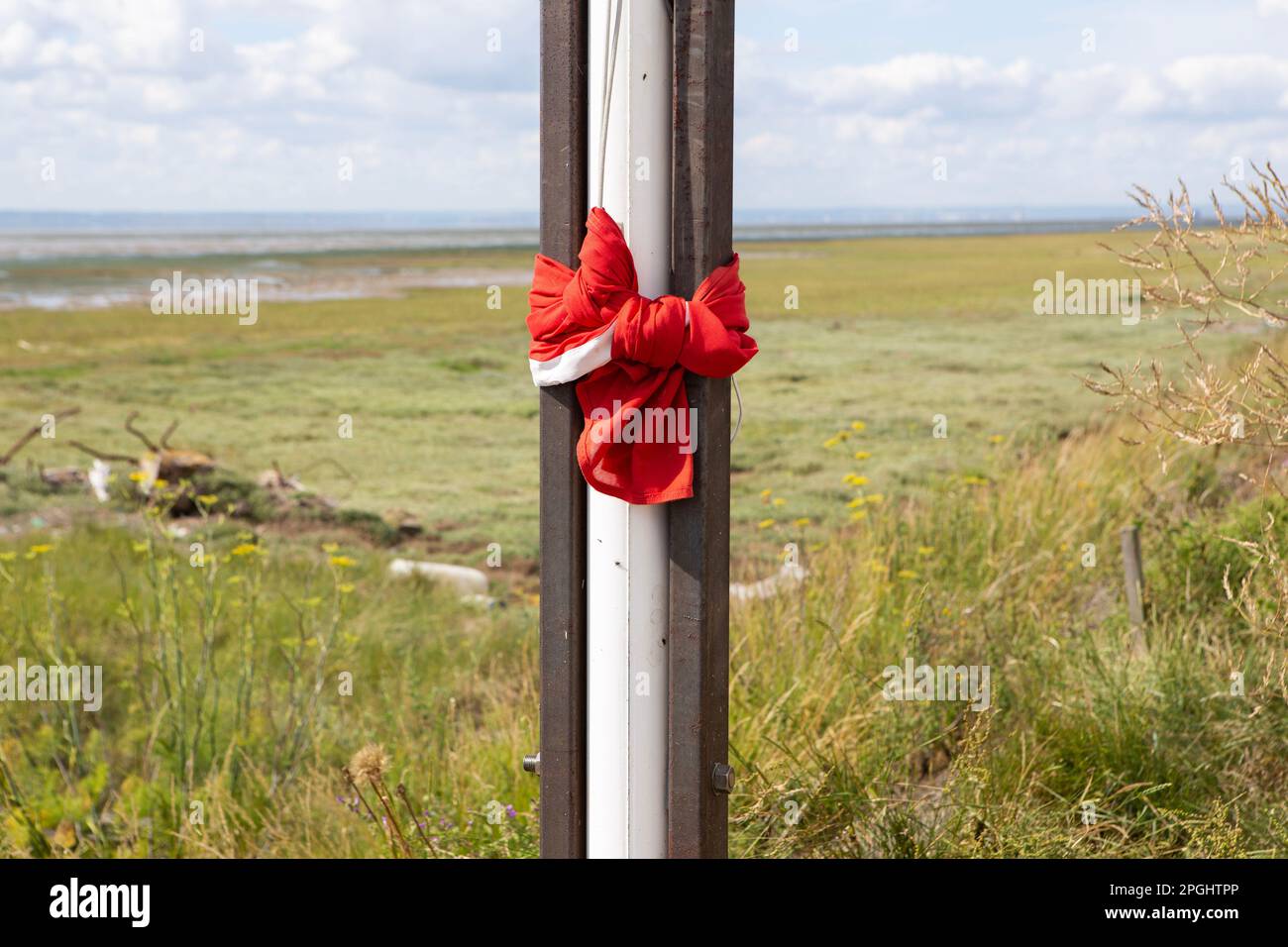 A red warning flag tied to a post, Foulness Island, Essex. When the ...